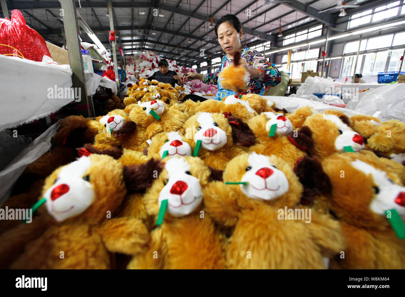 --FILE--A female Chinese worker makes toys to be exported to Europe and ...