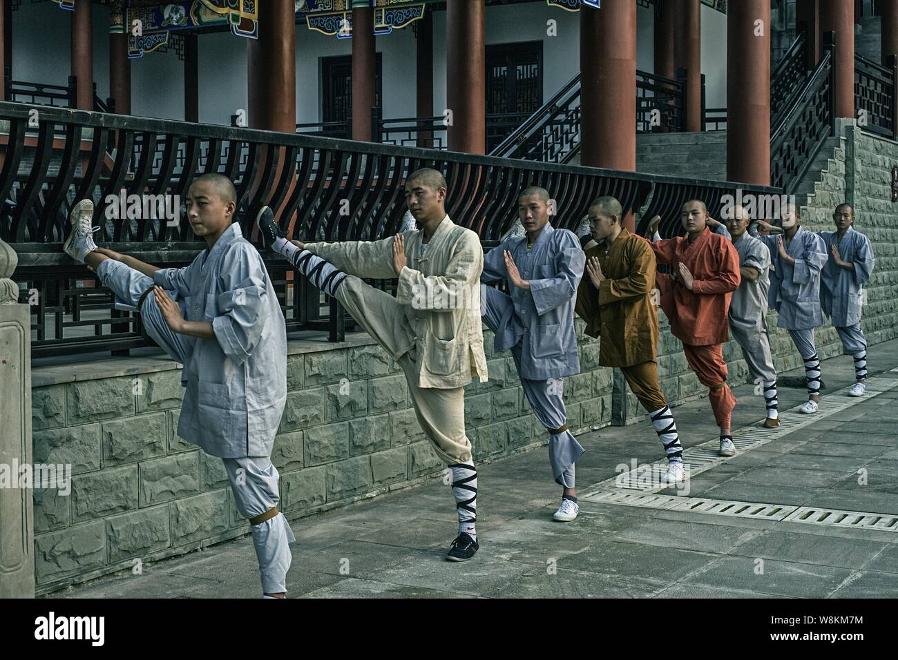 Chinese monks stretch their legs as they practise kungfu and martial ...