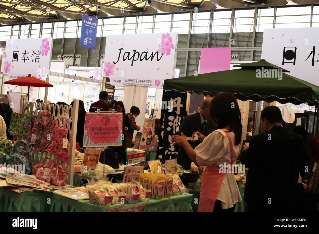 People visit a booth in the exhibition area for Japan during the 26th ...