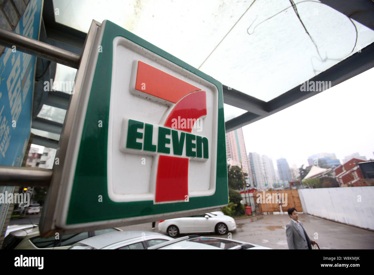 --FILE--A pedestrian walks past a convenience store of 7-Eleven in ...