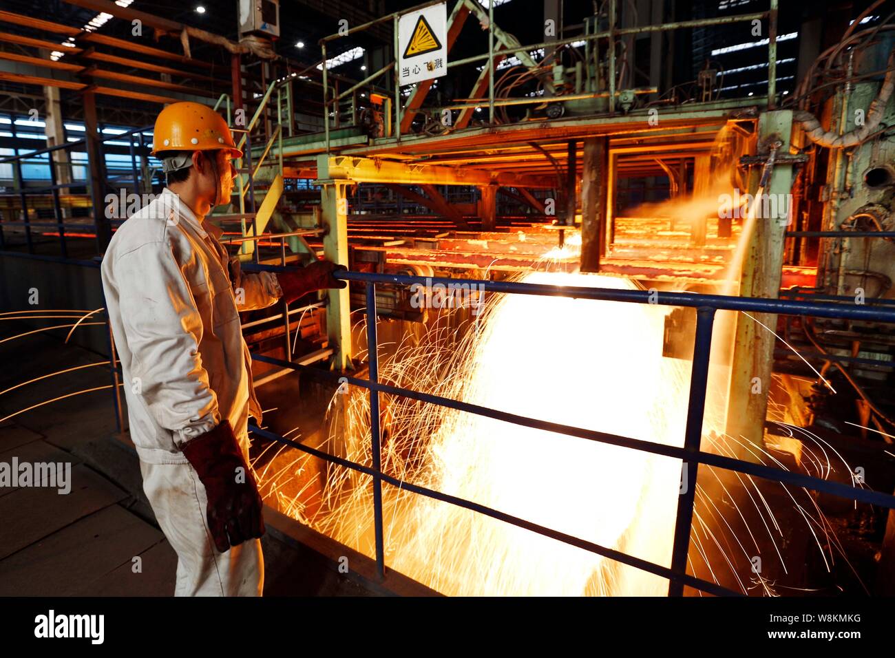 --FILE--A Chinese worker surveys the production of steel at a steel ...