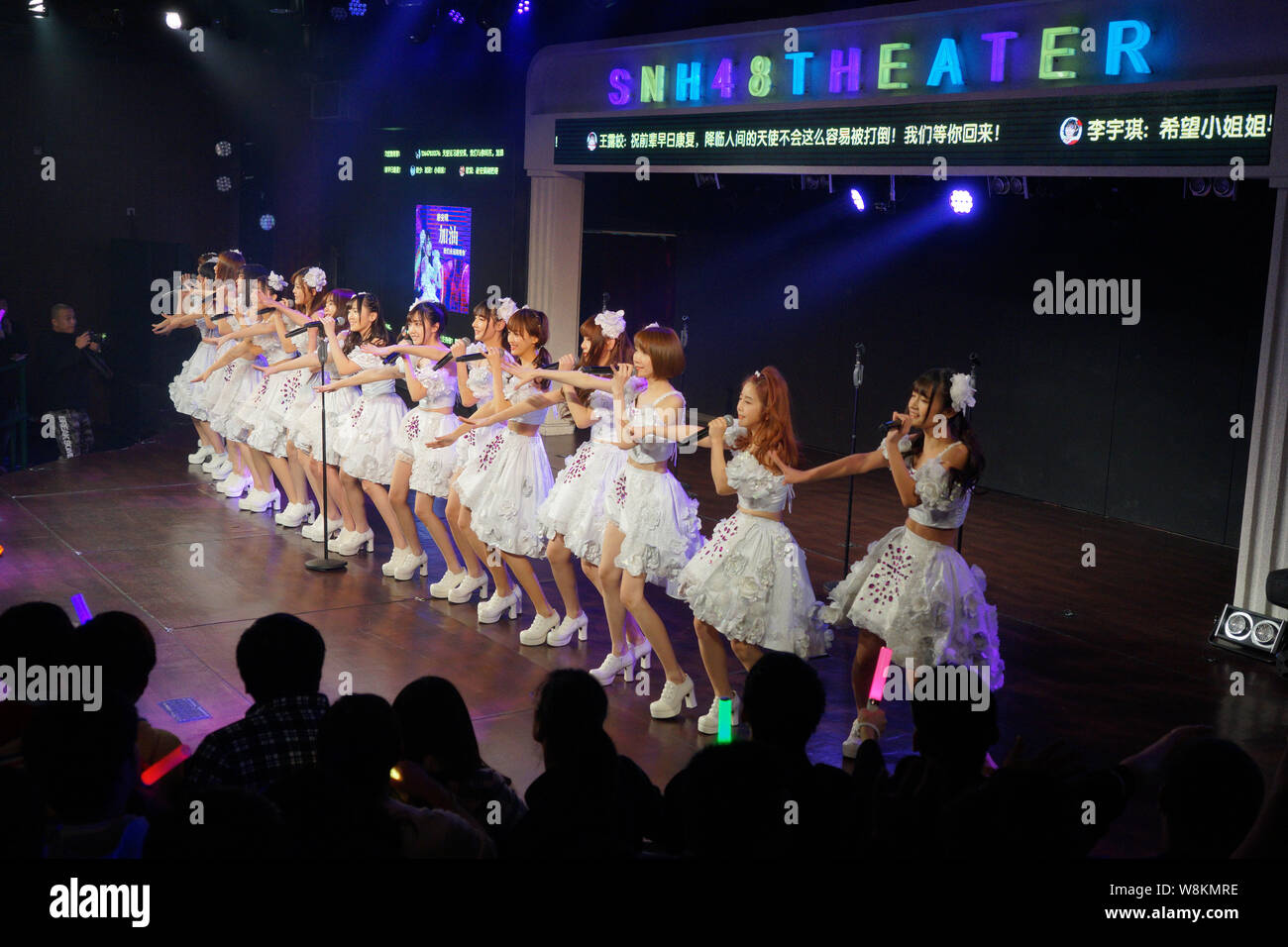 Members of Chinese girl group SNH48 perform at a concert to raise money ...