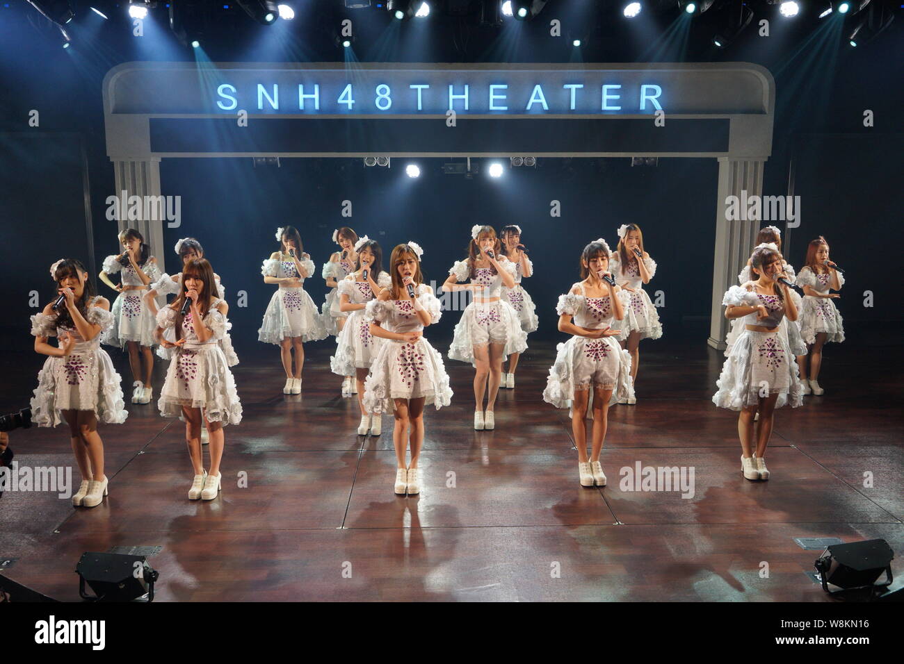 Members of Chinese girl group SNH48 perform at a concert to raise money ...
