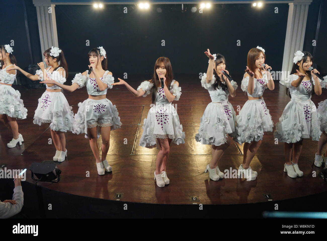 Members of Chinese girl group SNH48 perform at a concert to raise money ...