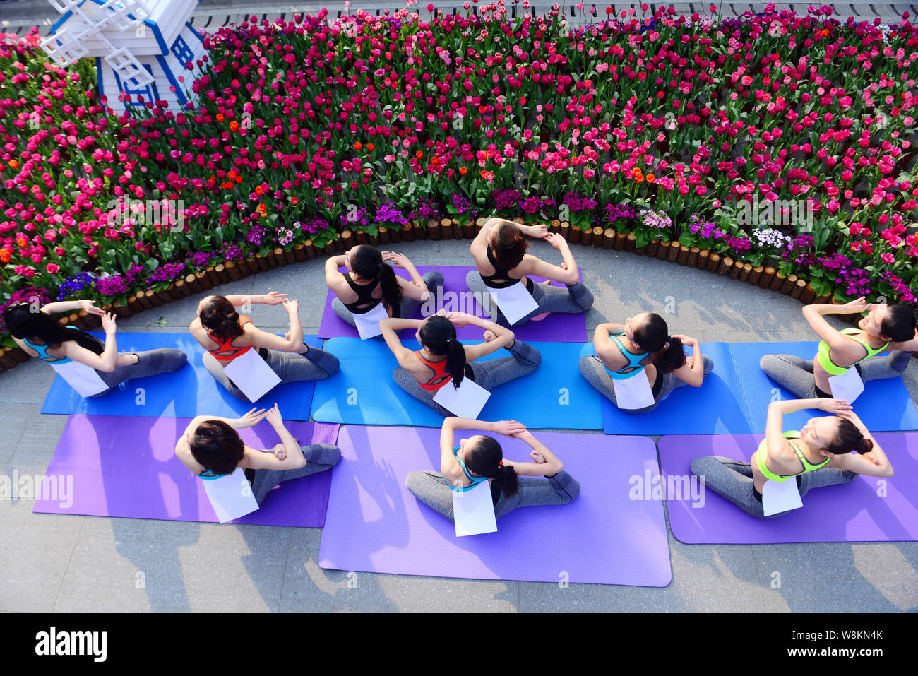 Young Chinese women who have their slim waists covered with A4-size ...