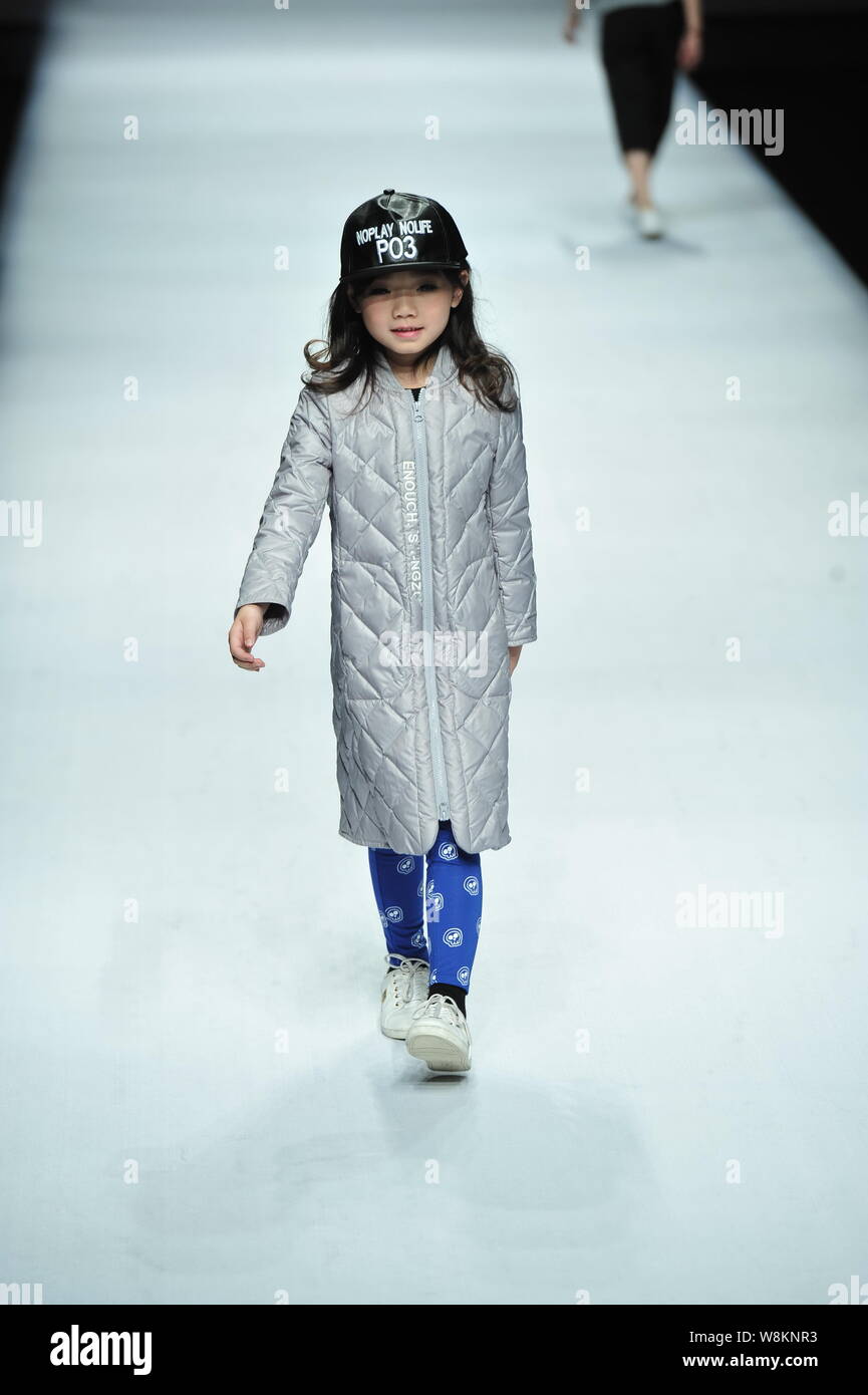 A child model displays a new creation at the fashion show of Tingzu ...