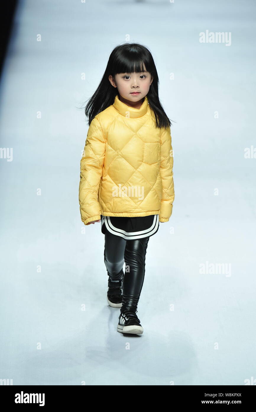 A child model displays a new creation at the fashion show of Tingzu ...