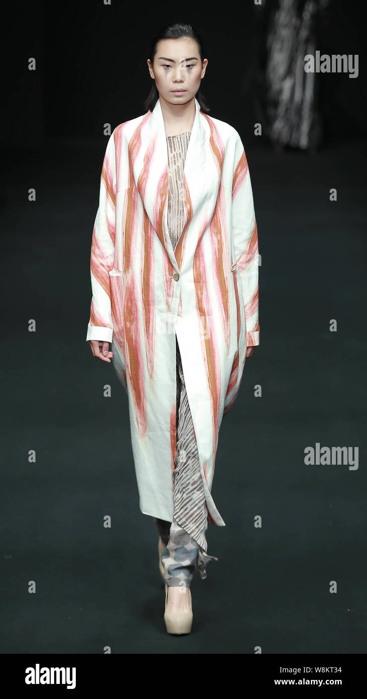 A model displays a new creation at the fashion show of Xinshen Linen ...