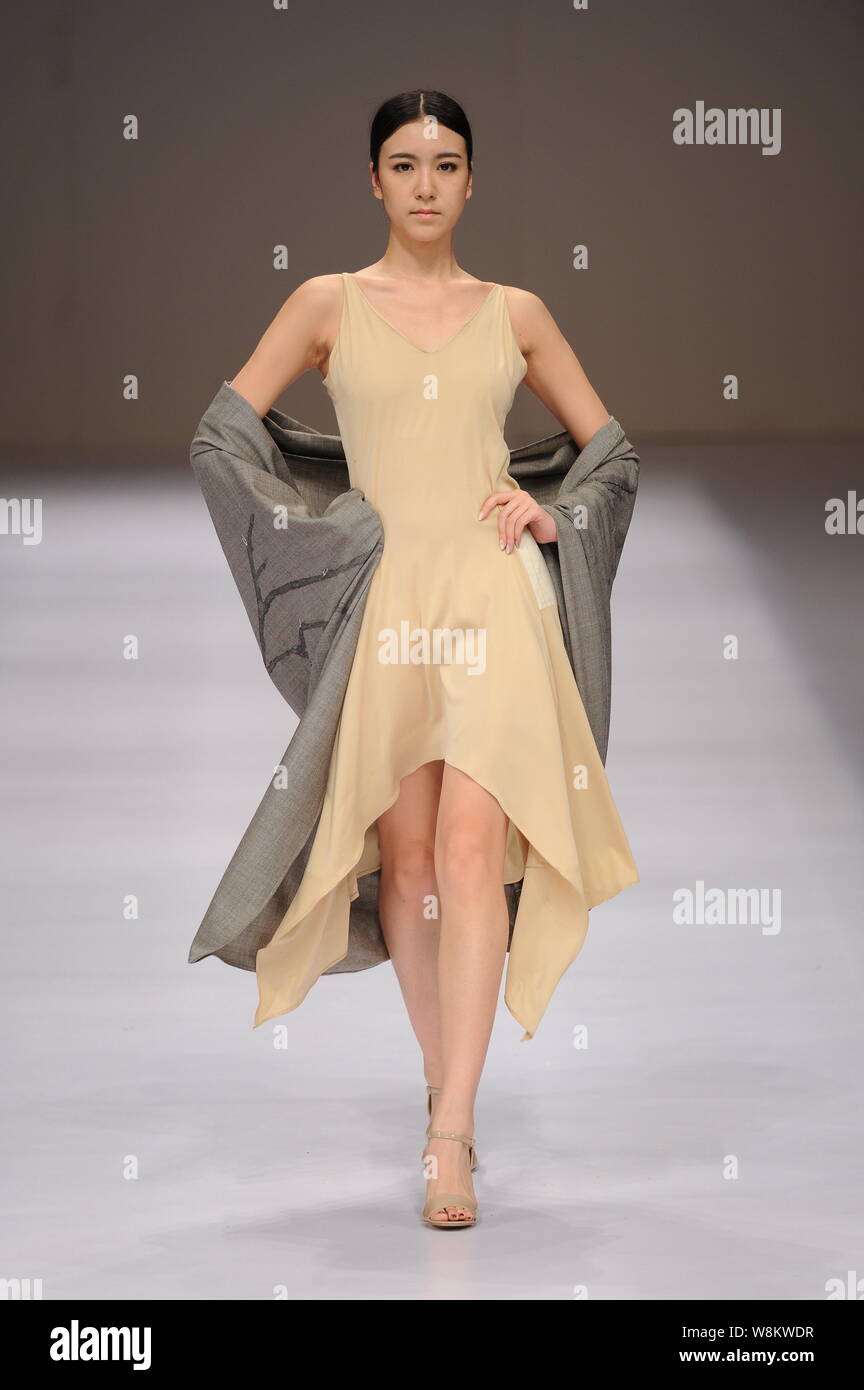 A model displays a new creation from the Beijing Institute of Fashion ...