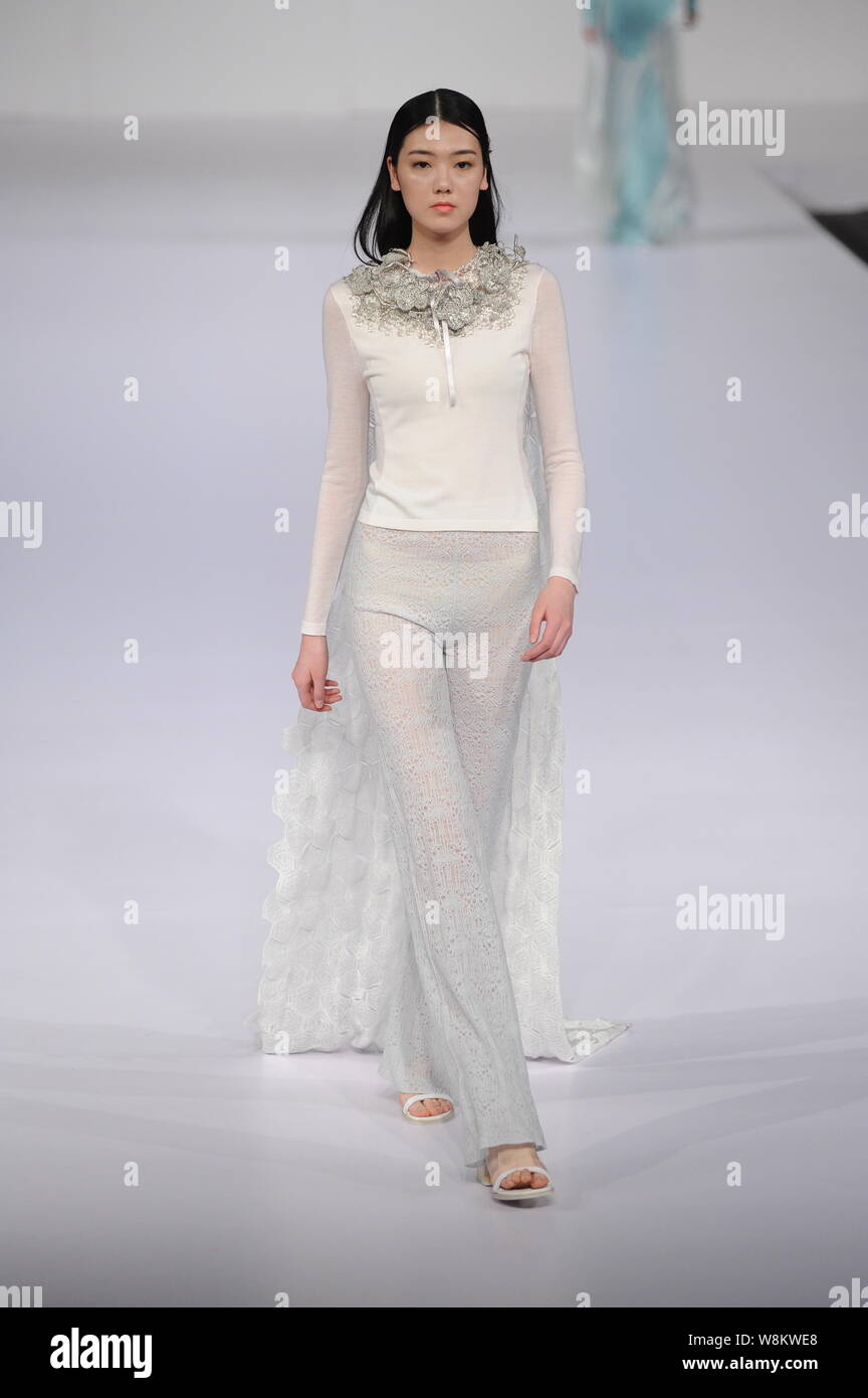 A model displays a new creation by Chinese designer Guo Ruiping at the ...
