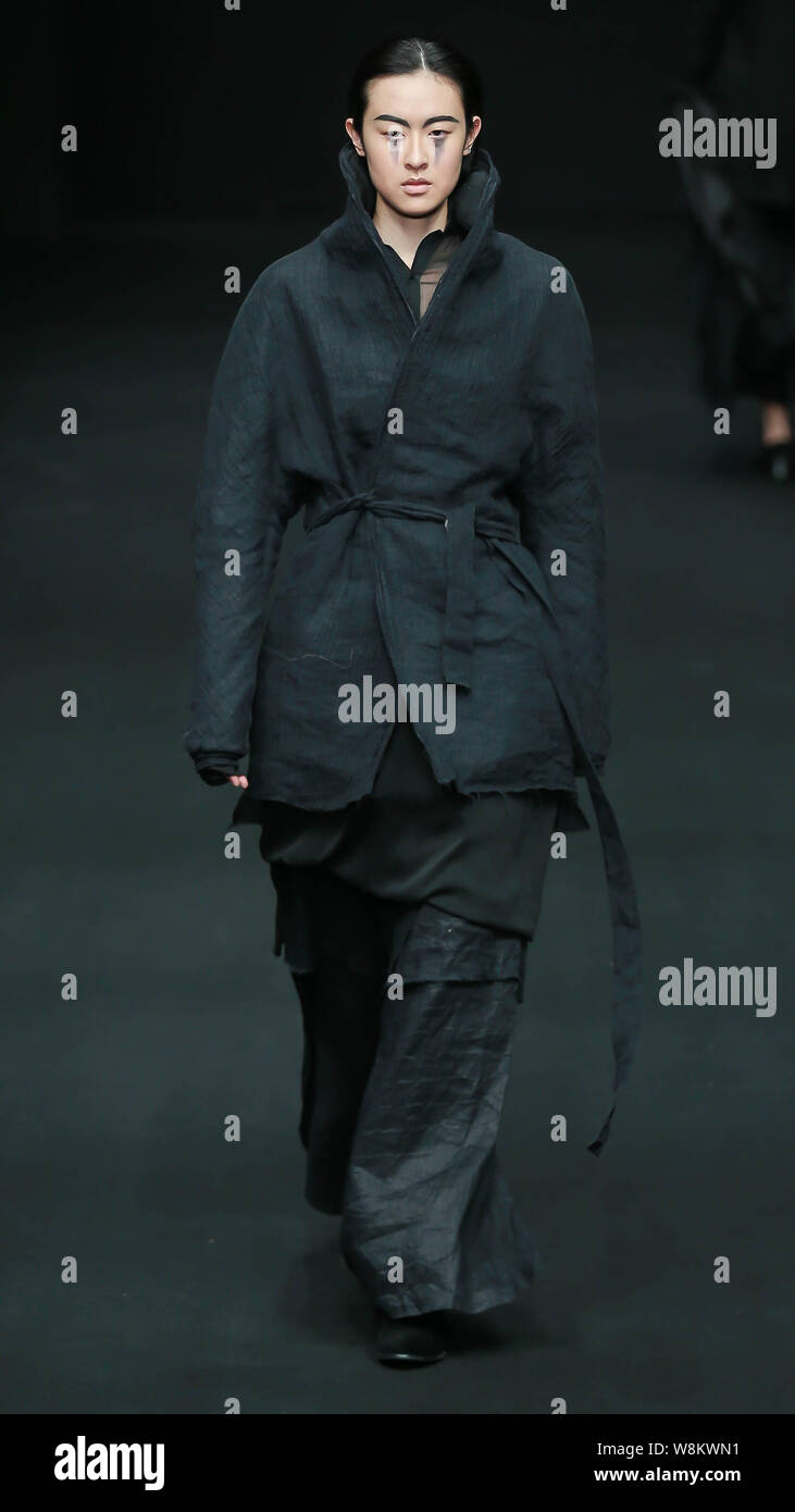 A model displays a new creation at the fashion show of Xinshen Linen ...