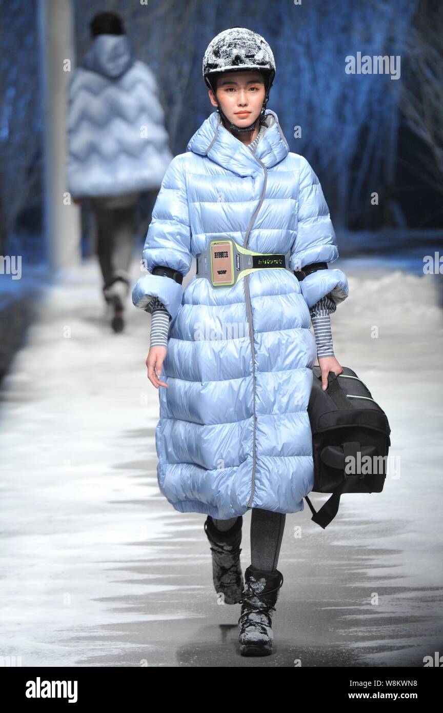 A model displays a new creation at the fashion show of Bosideng China ...