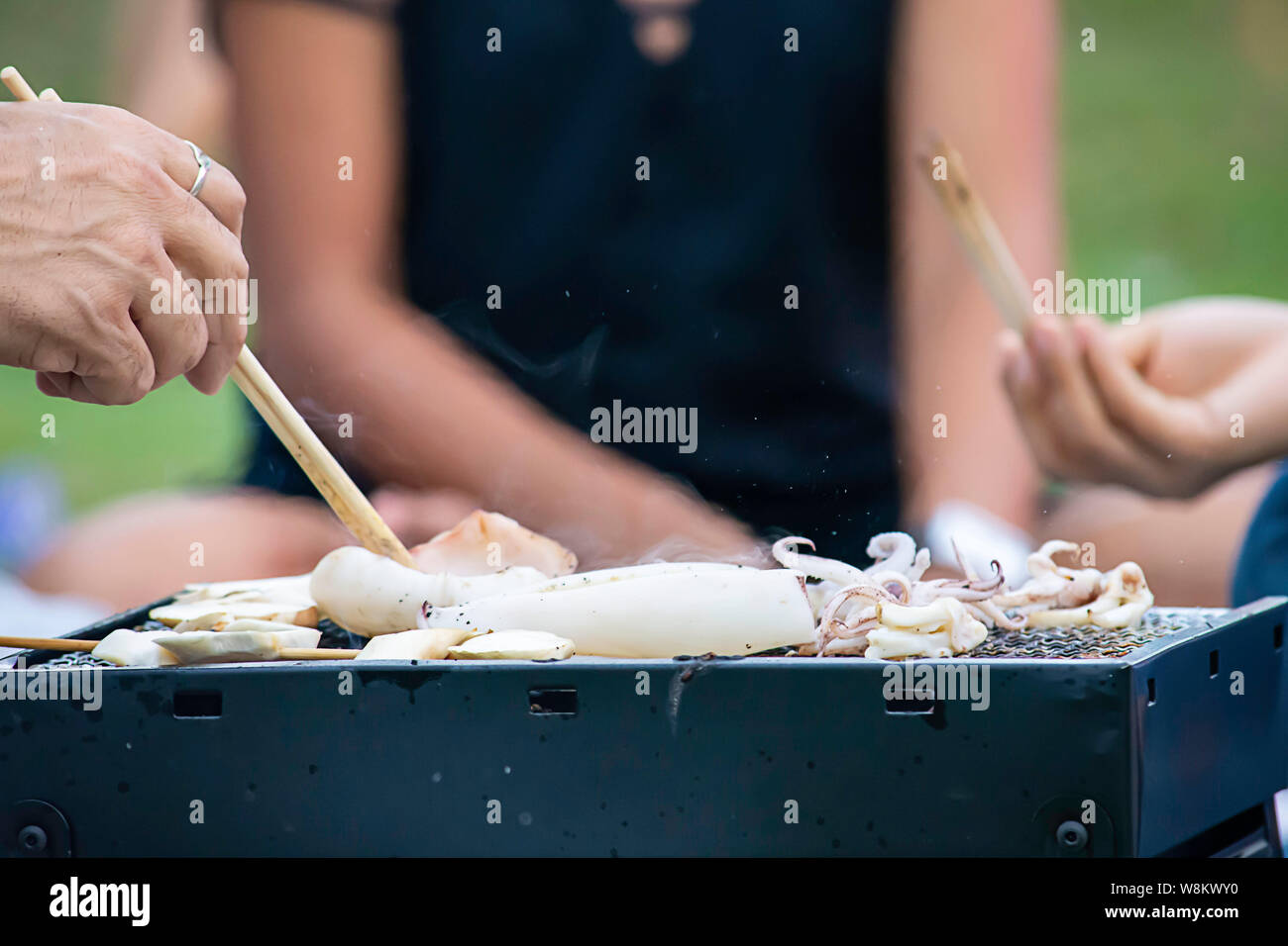 Fresh squid and mushrooms on the grill grate steel Stock Photo - Alamy