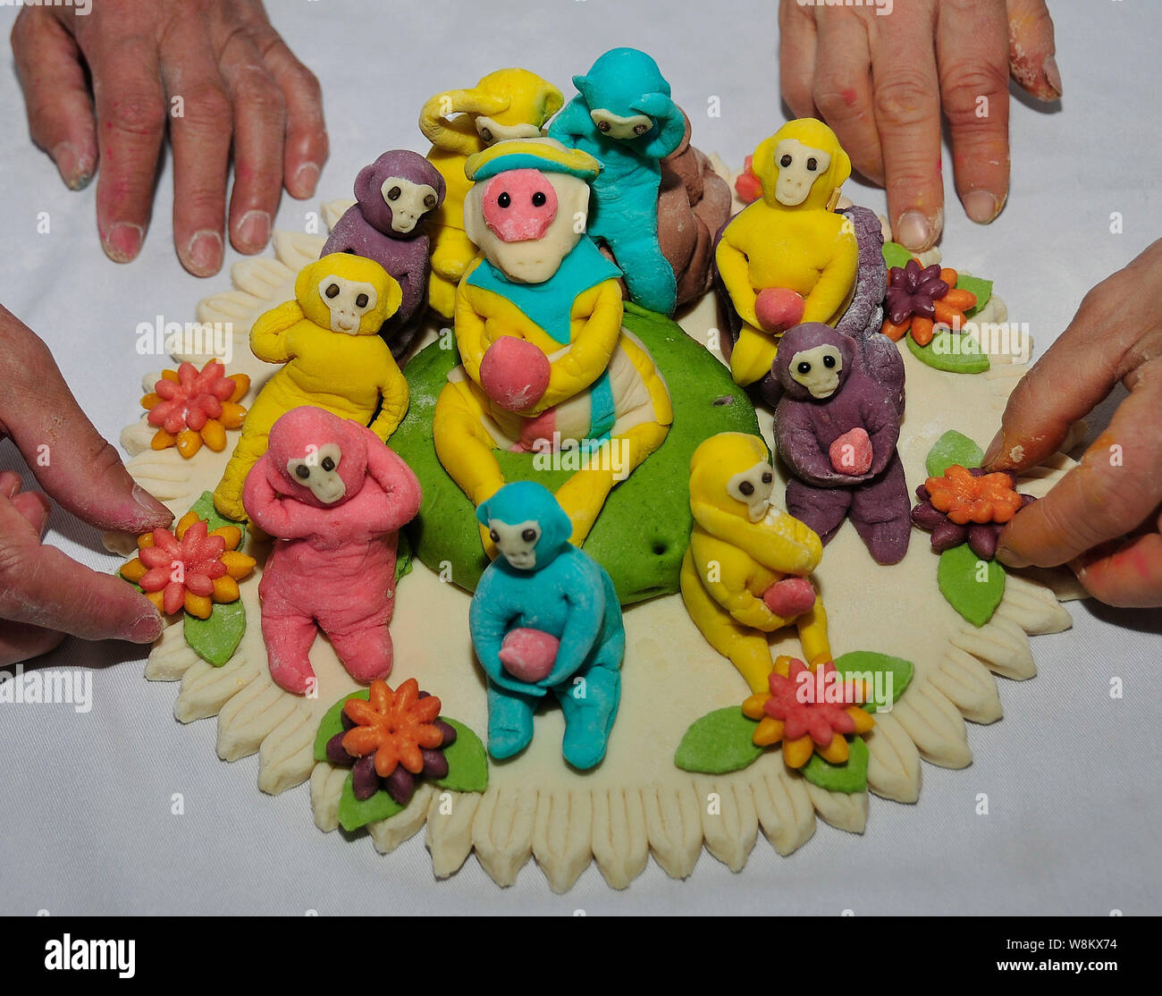 Folk artists of dough modeling create a work featuring monkeys to ...