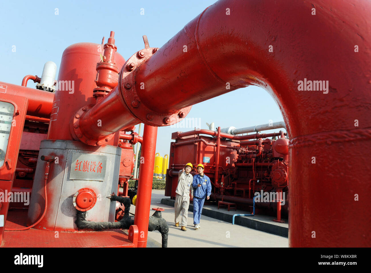 --FILE--Chinese workers check crude oil production facilities at the ...