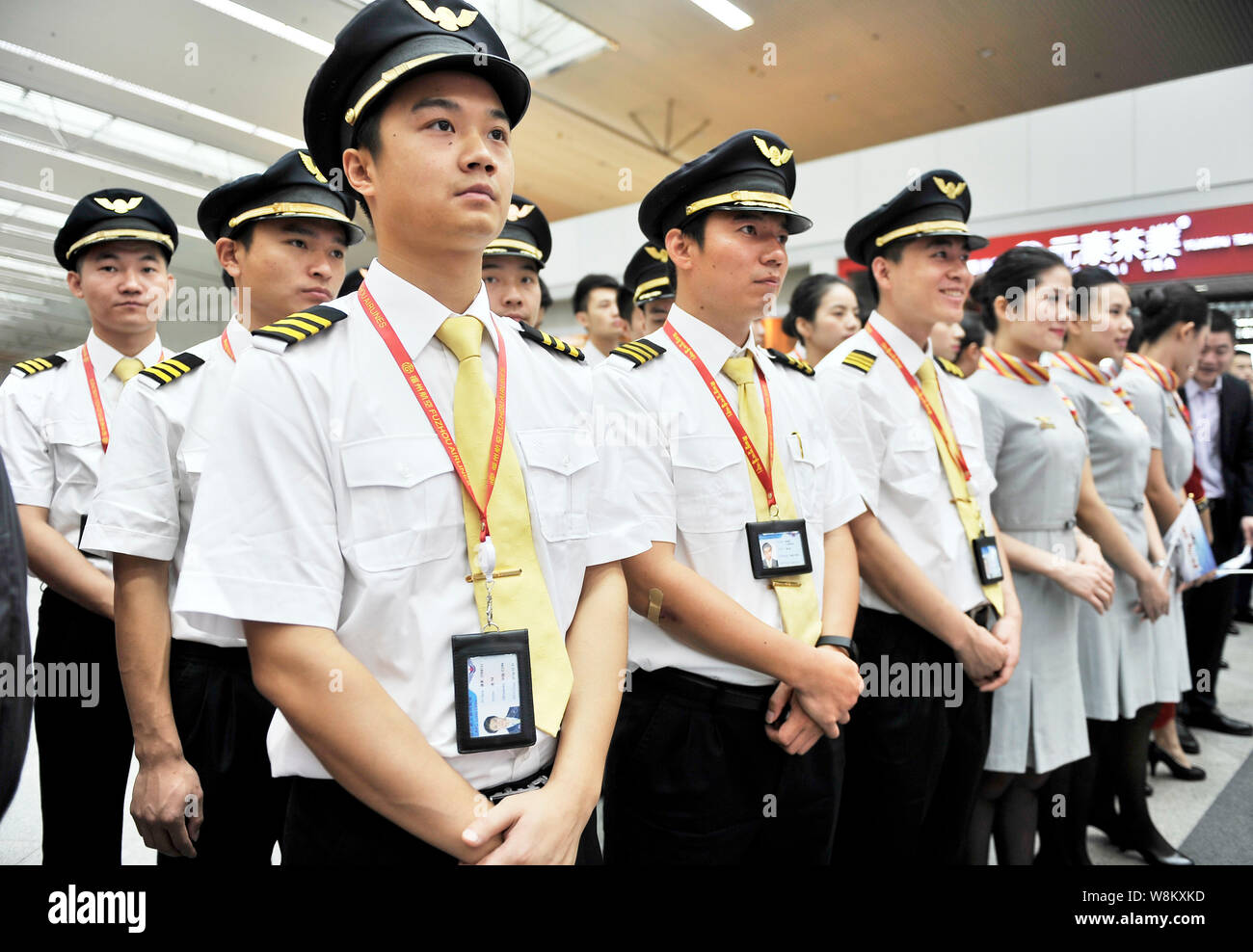 File Chinese Pilots And Air Hostesses Pose During A Ceremony For Fuzhou Airlines In Fuzhou