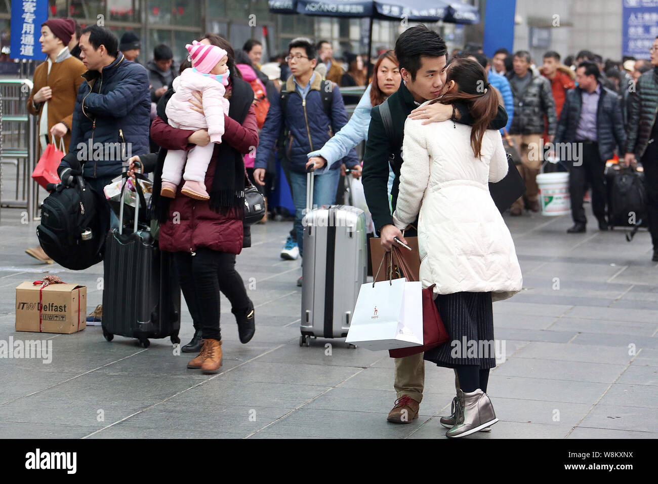 A couple of Chinese lovers hug each other to bid farewell at the ...