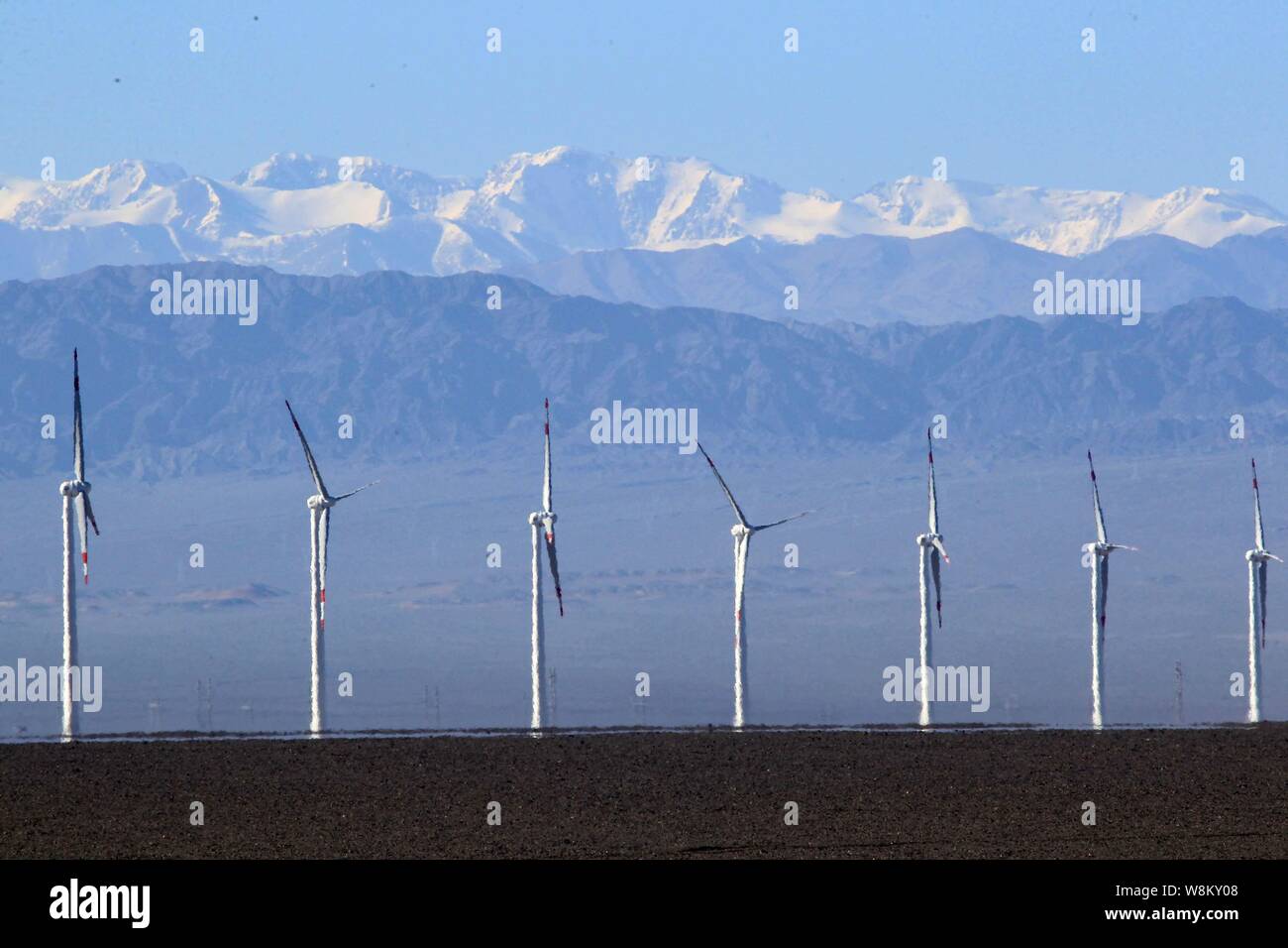 --FILE--Wind turbines whirl to generate electricity at a wind farm in ...