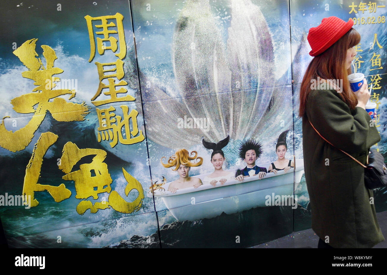 A Chinese filmgoer walks past a poster of the movie "The Mermaid ...