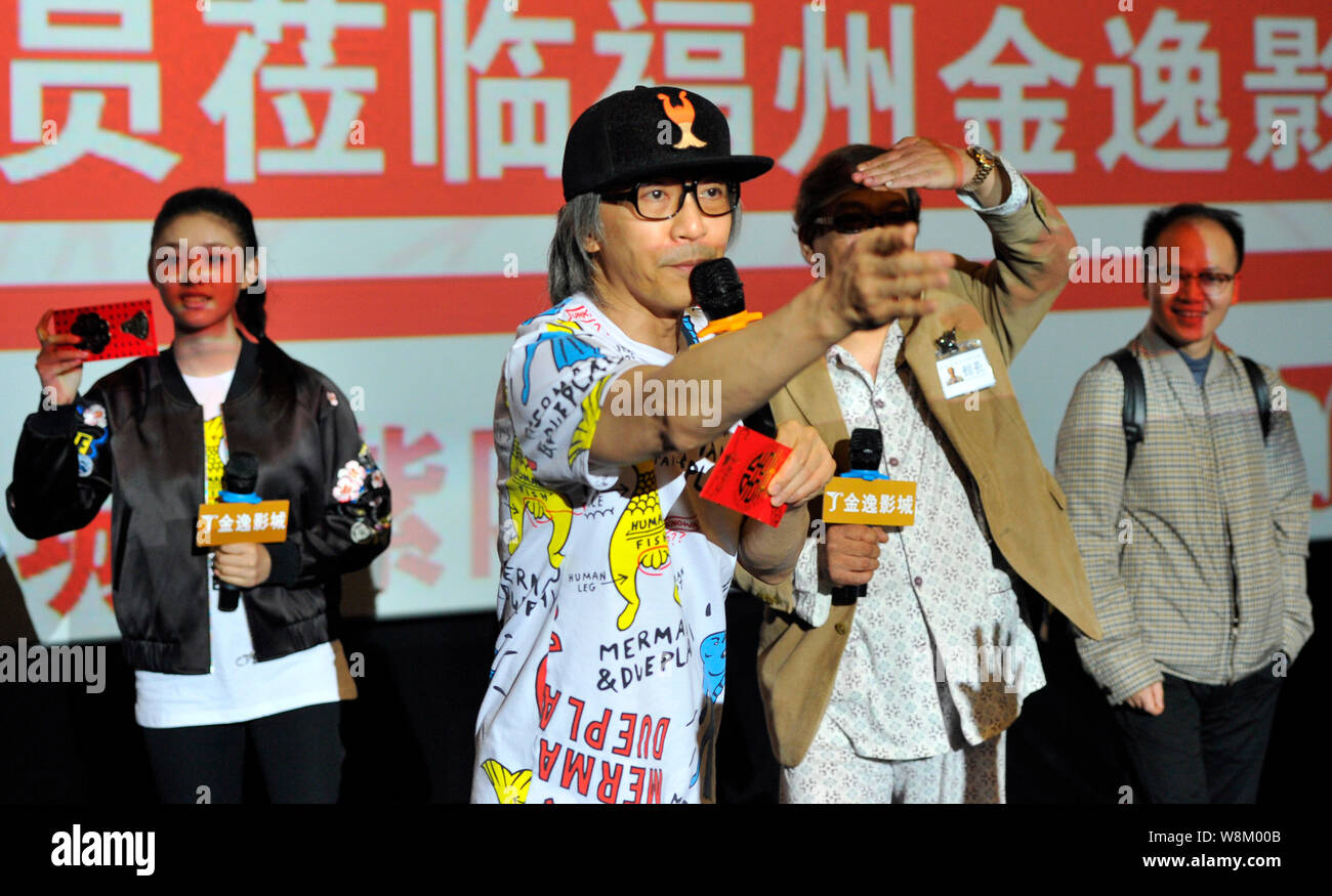 Hong Kong director Stephen Chow, center, speaks as he holds a red ...