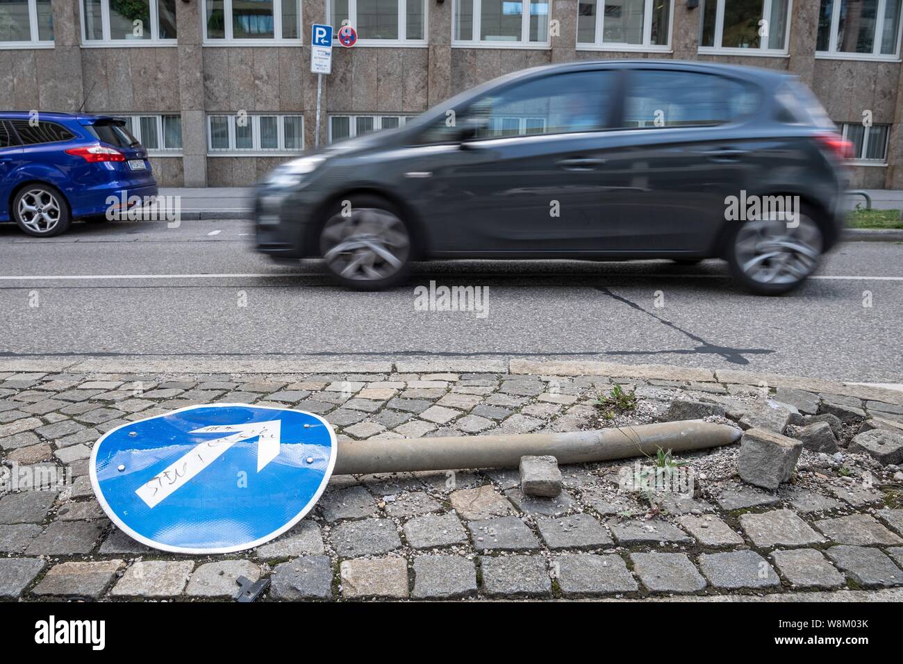 Munich, Germany. 08th Aug, 2019. A car drives past a damaged traffic ...