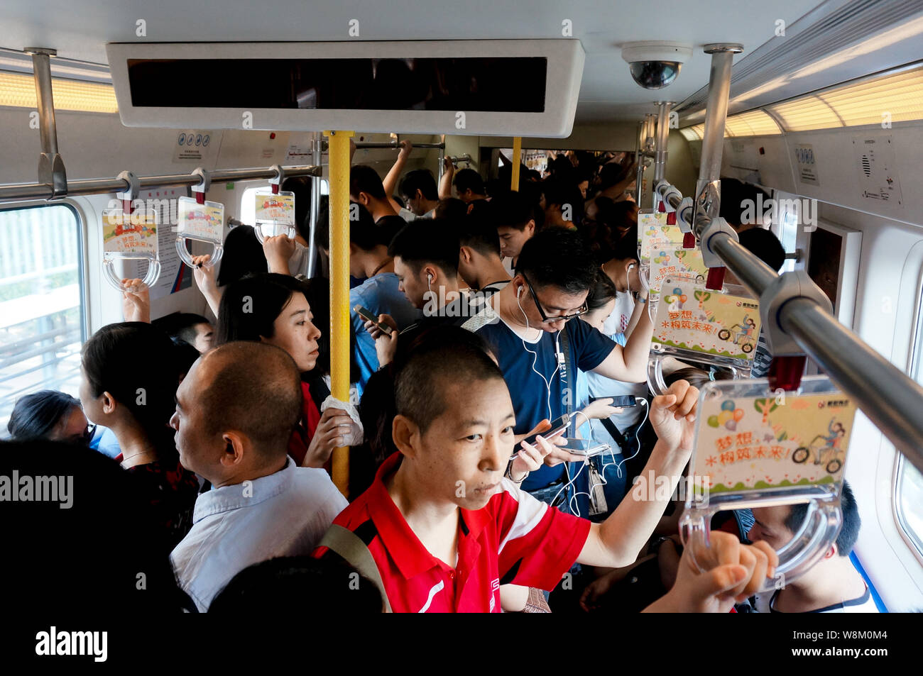 --FILE--Passengers crowd a subway train in Beijing, China, 14 July 2015 ...