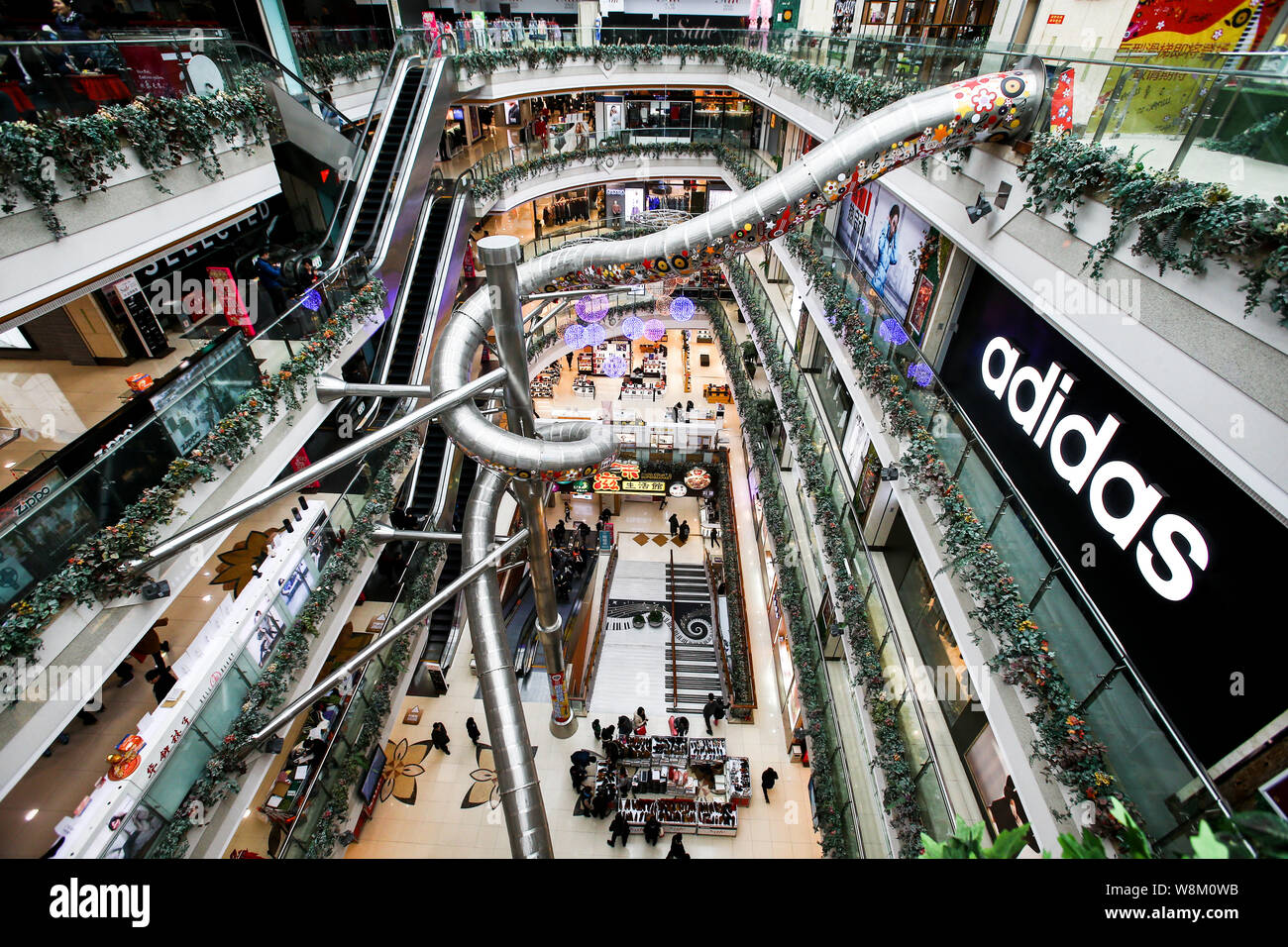View of a five-story high giant winding slide in a shopping mall in ...