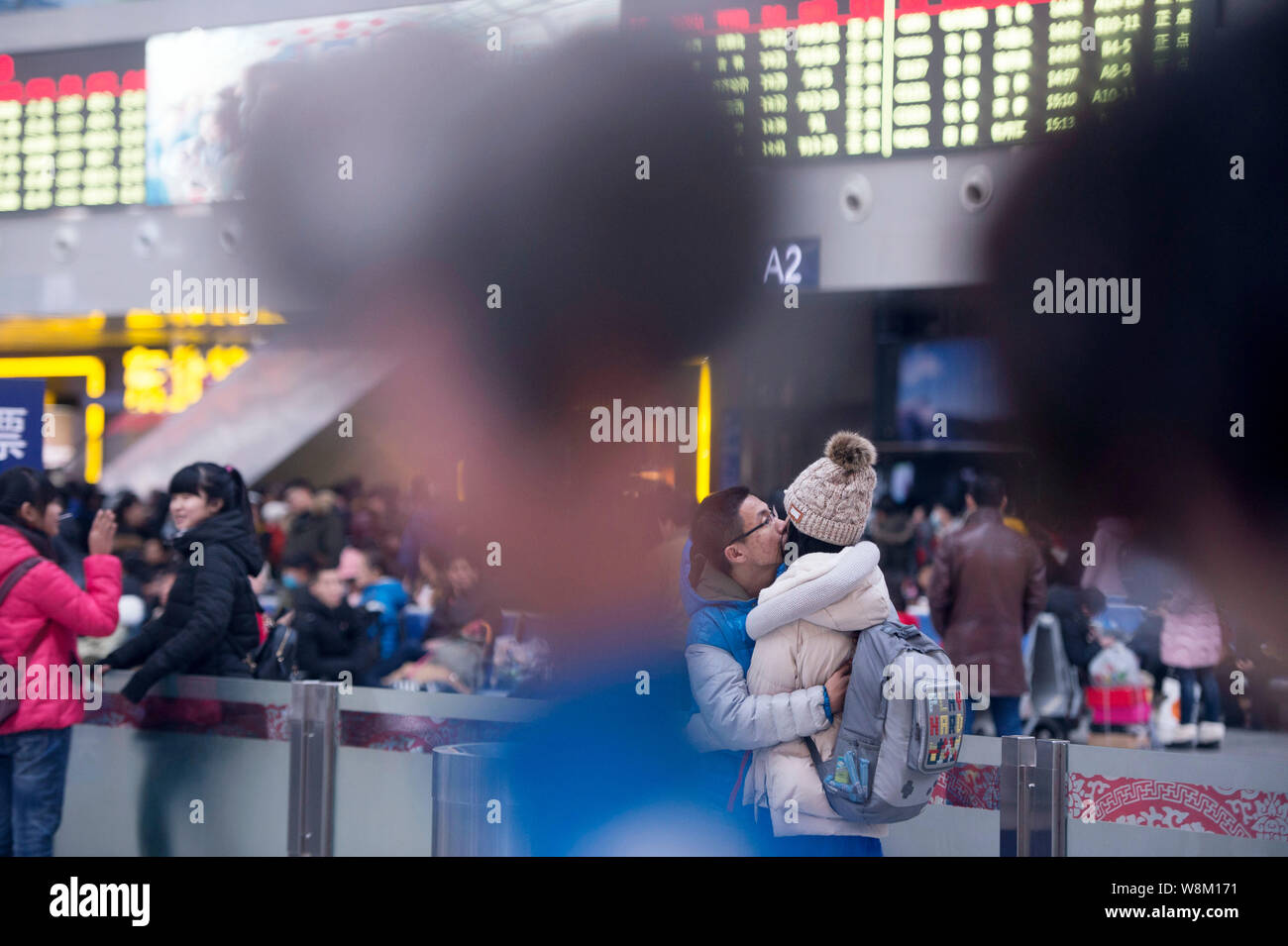A couple of Chinese lovers kiss each other to bid farewell at the ...