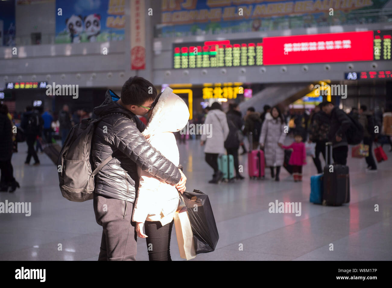 A couple of Chinese lovers kiss each other to bid farewell at the ...