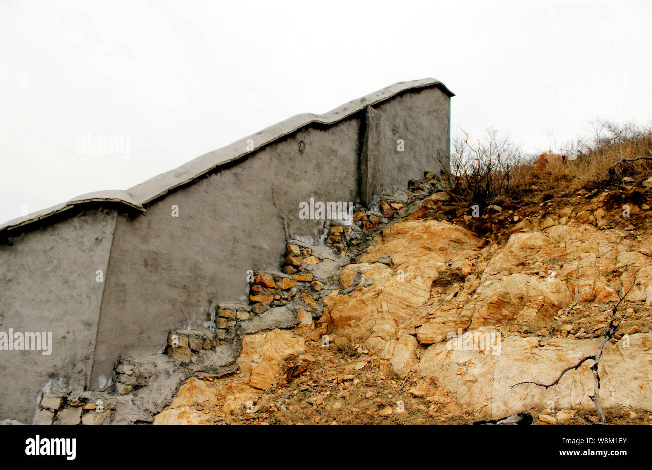 A long enclosing wall is built on the side of a mountain in east China ...
