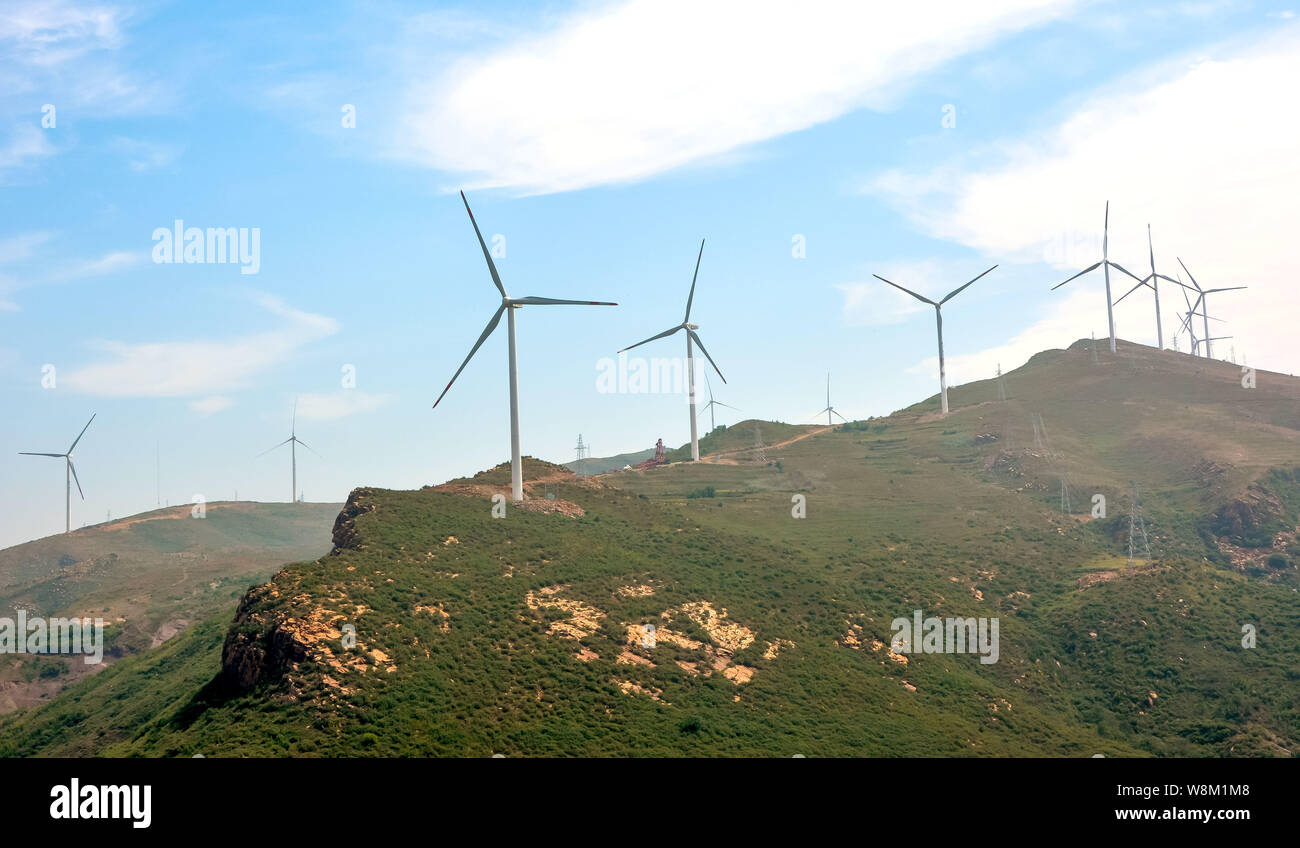 --FILE--Wind turbines whirl to generate electricity at a wind farm in ...