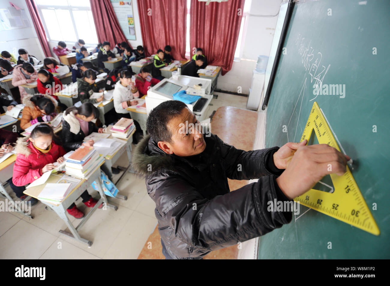 --FILE--A male Chinese teacher gives a mathematics lesson to his ...
