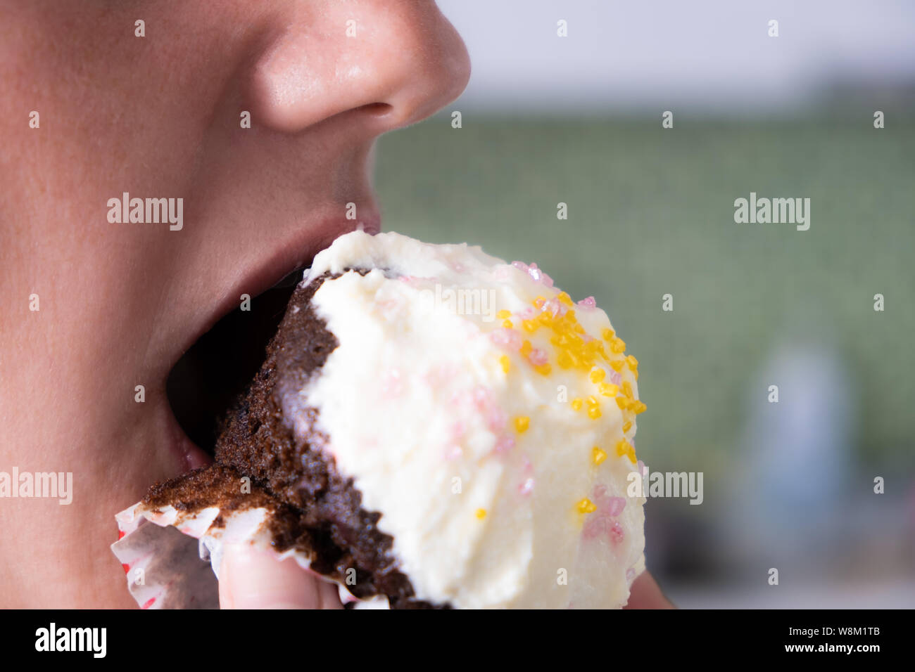 The female mouth bites the cake. Cake. Close-up Stock Photo - Alamy
