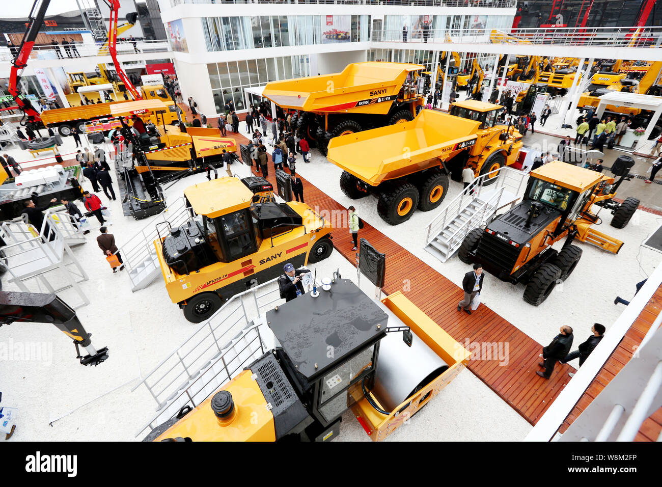 --FILE--Visitors look at construction machineries of Sany on display ...