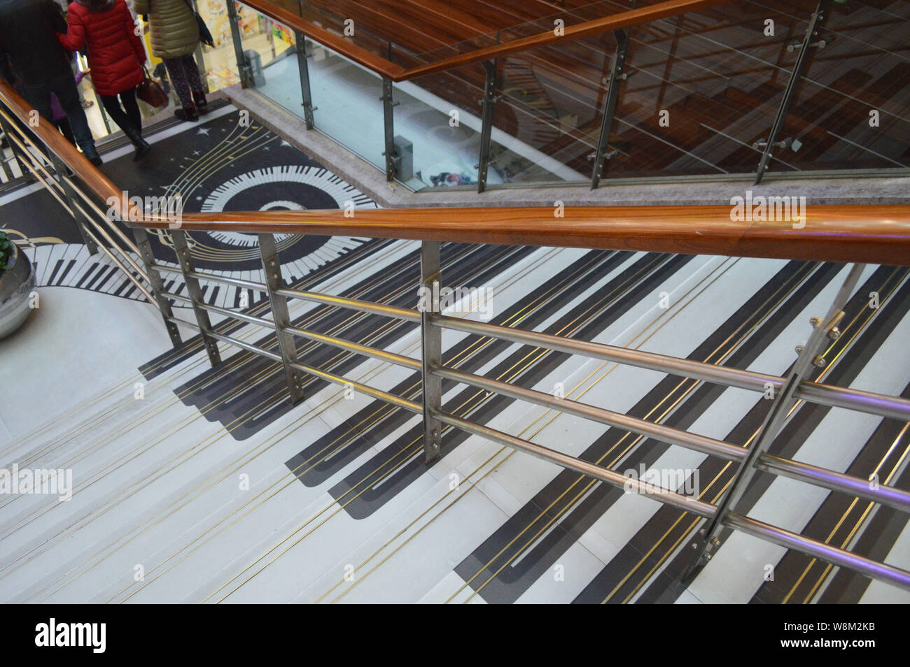 Chinese customers walk on a "piano staircase", which plays musical ...