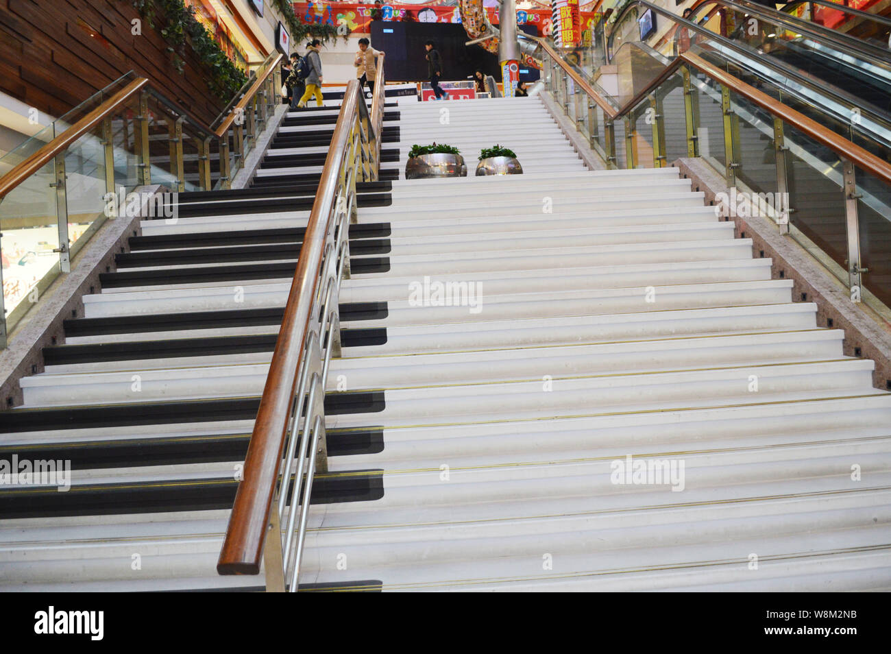 Chinese customers walk on a "piano staircase", which plays musical ...