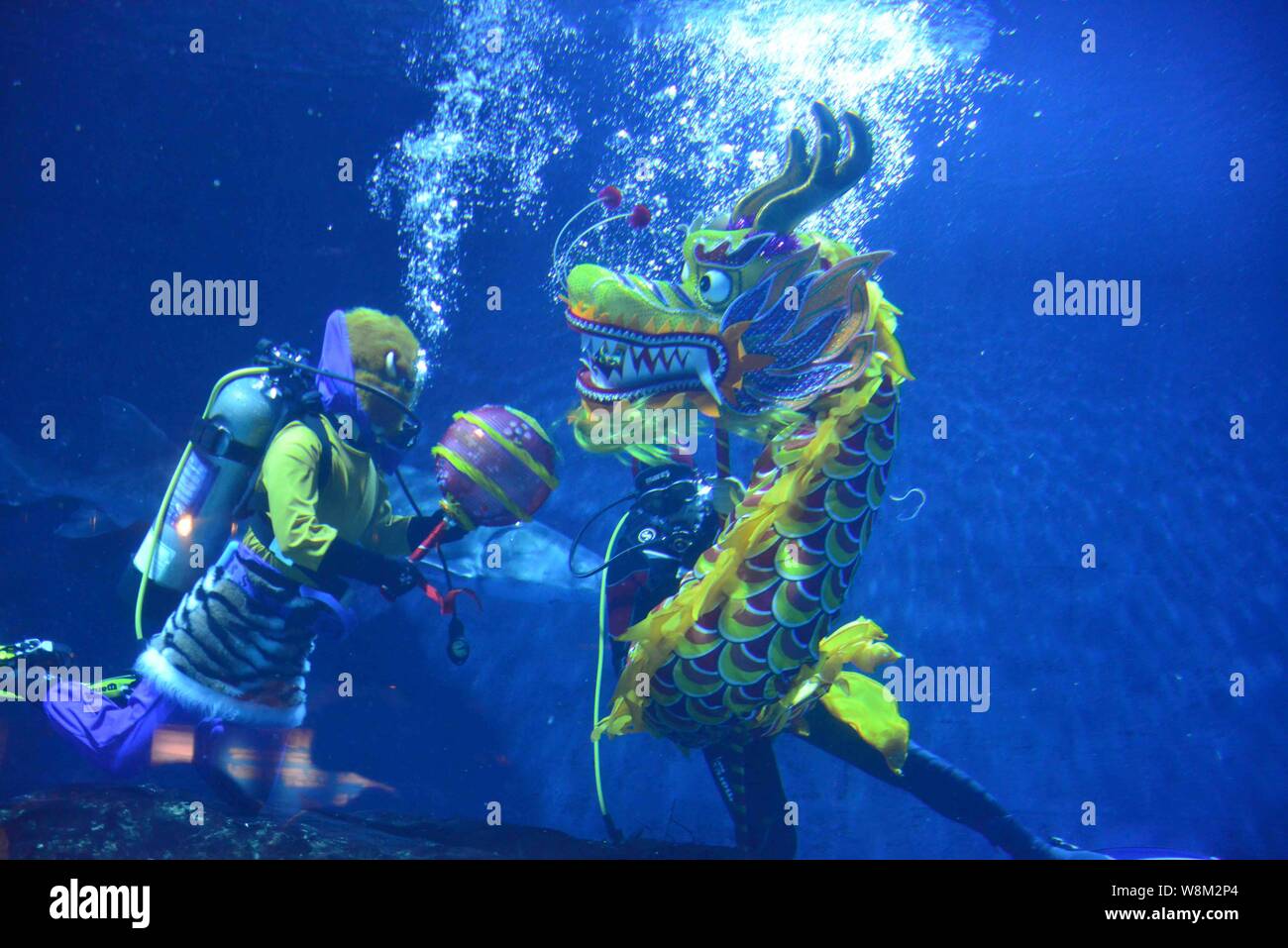 Chinese divers dressed in the diving suits of "Monkey King" and dragon ...