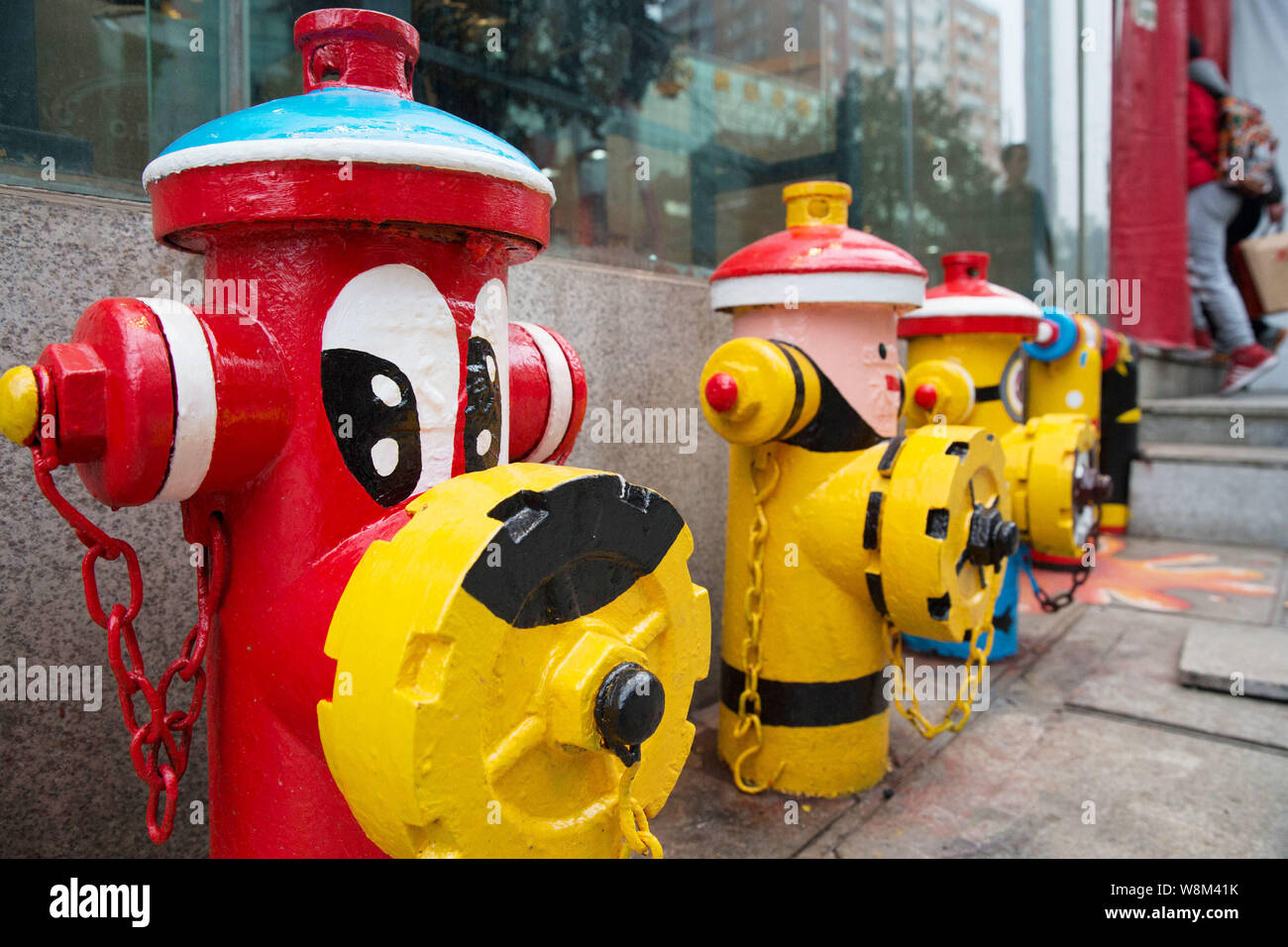 View of hydrants painted with cartoon images on a road in Nanjing city ...