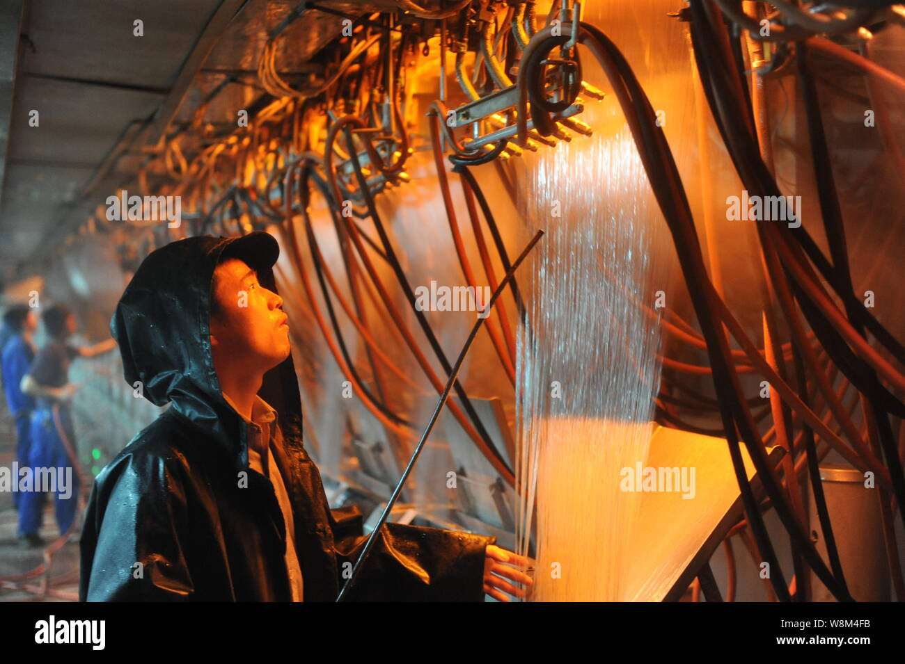 --FILE--Chinese workers manufacture fibreglass at a plant of China ...