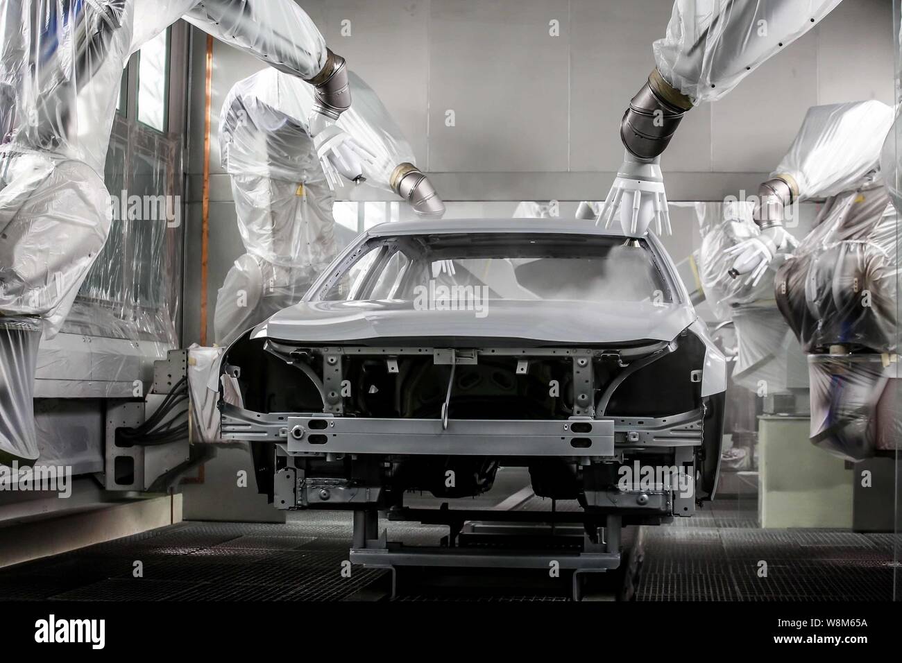 A car is being sprayed-paint on the assembly line at the GM Shanghai ...