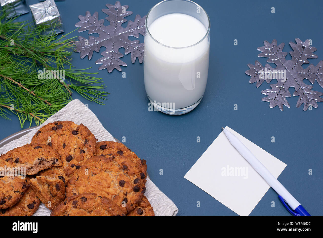 Milk, chocolate cookies and a note for Santa Claus Stock Photo - Alamy