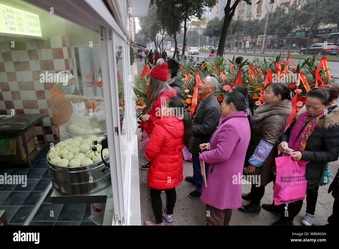 Local Chinese residents queue up to buy steamed stuffed buns at the ...