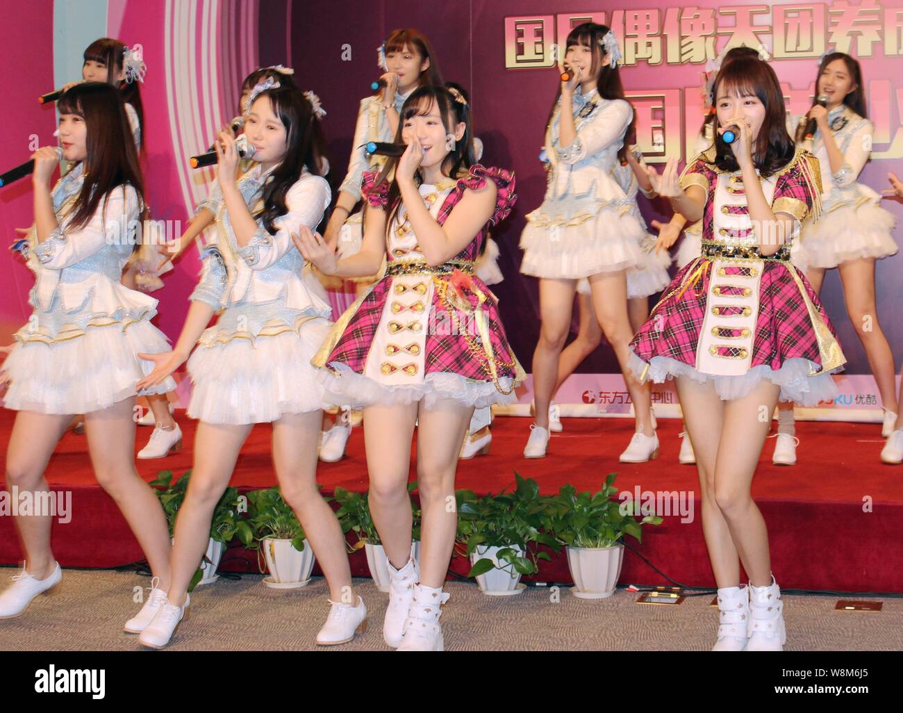 Chinese young girl group SNH48 sings and dances during a press ...