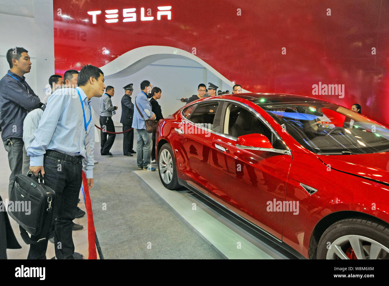 --FILE--Visitors look at a Tesla Model S electric car during the 2nd ...