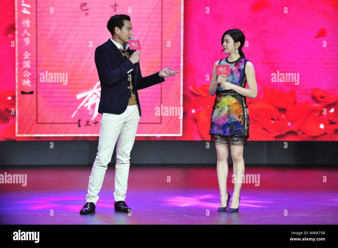 Taiwanese actor Eddie Peng, left, speaks to actress Michelle Chen at a ...