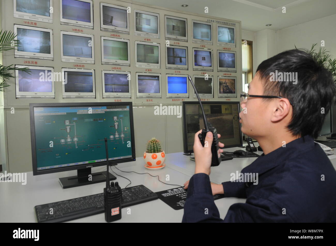 --FILE--A Chinese worker monitors the production of cement in the ...