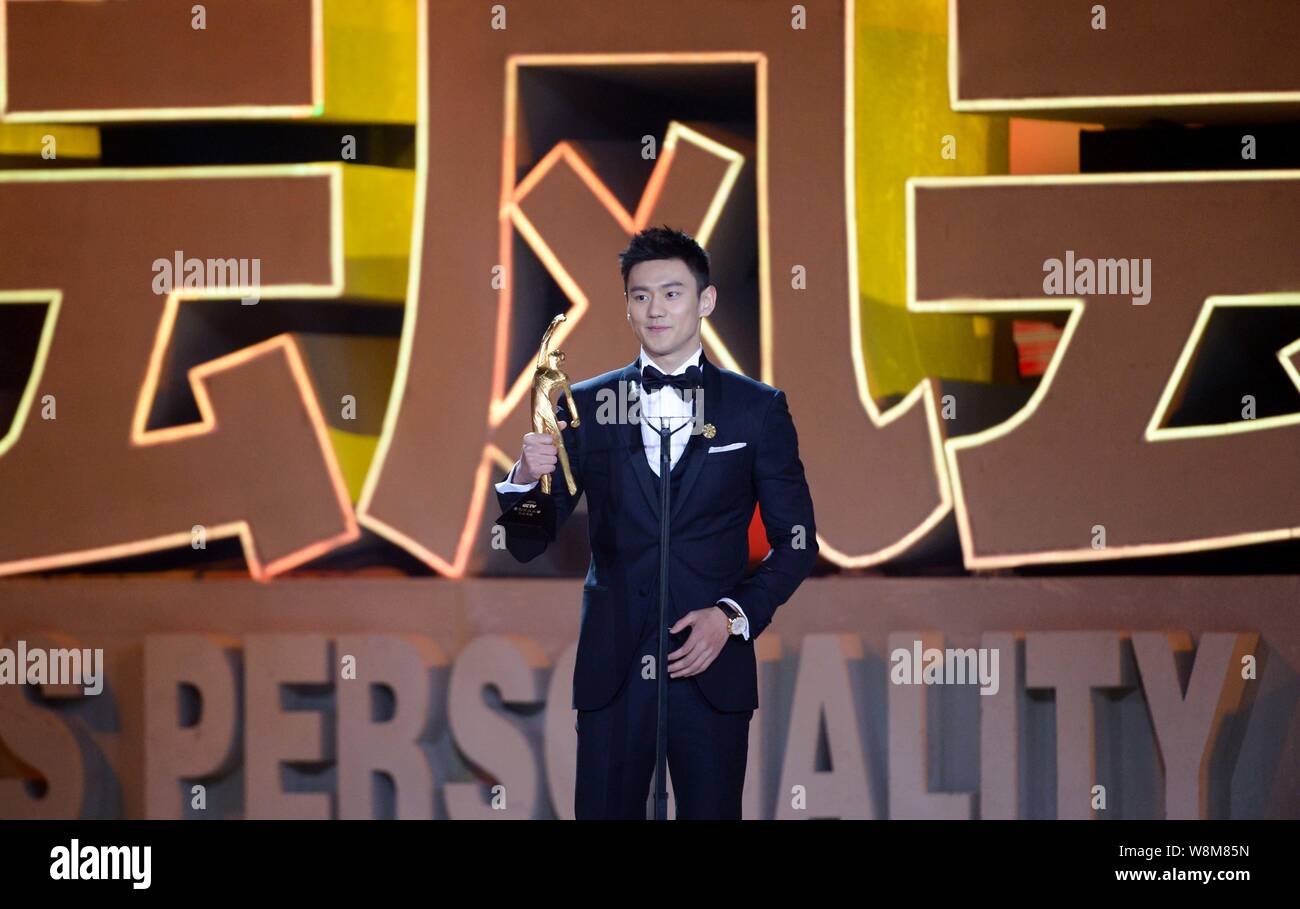 Chinese world swimming champion Ning Zetao holds his trophy for the ...