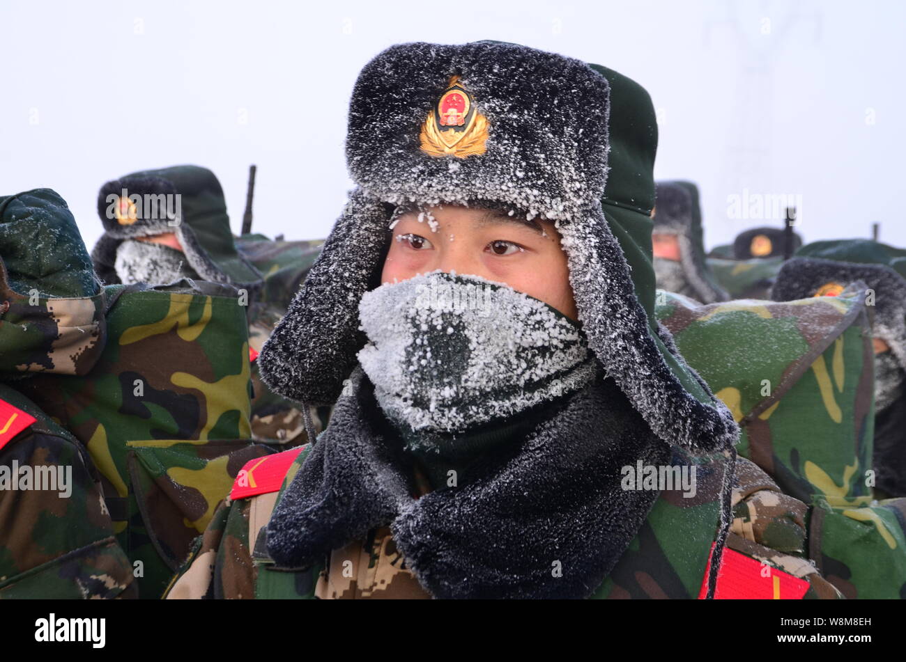 Ice and frost are seen on the masks and hats of Chinese paramilitary ...