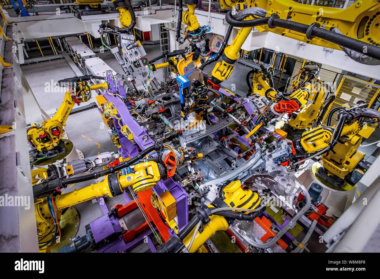 A car is being assembled on the assembly line at the GM Shanghai ...