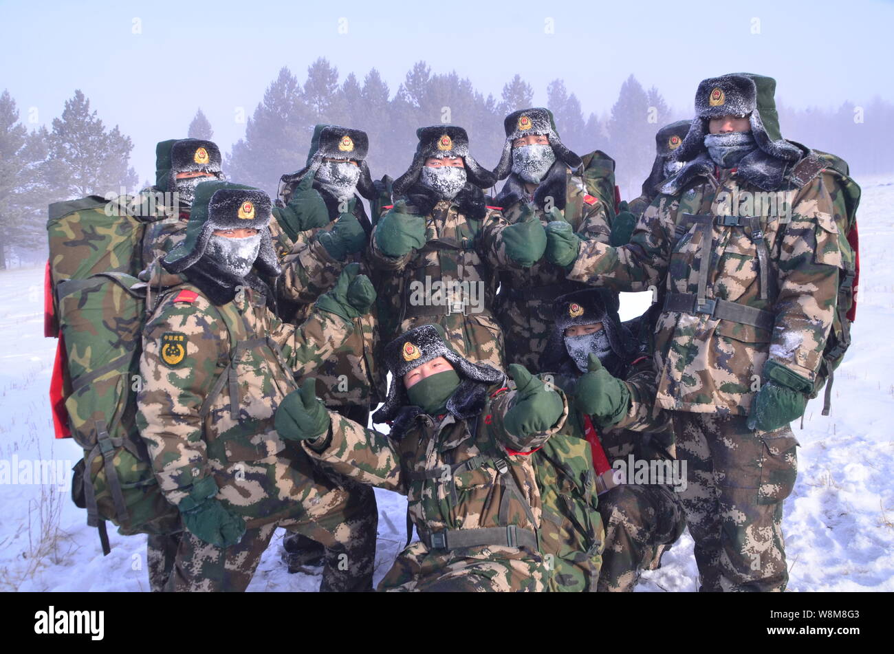 Chinese paramilitary policemen pose for pictures as they march on the ...